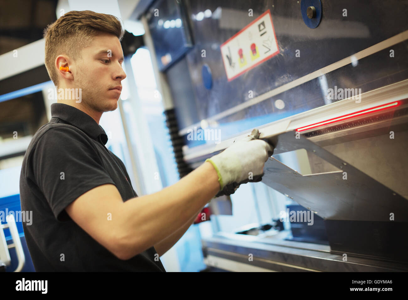 Worker operating machinery in steel factory Stock Photo - Alamy