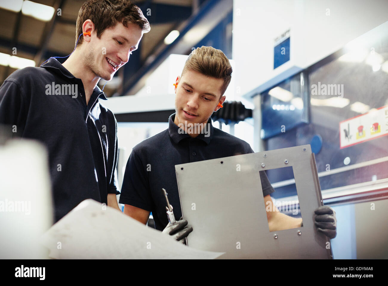Workers reviewing paperwork in steel factory Stock Photo - Alamy Workers reviewing paperwork in steel factory Stock Photo - Alamy