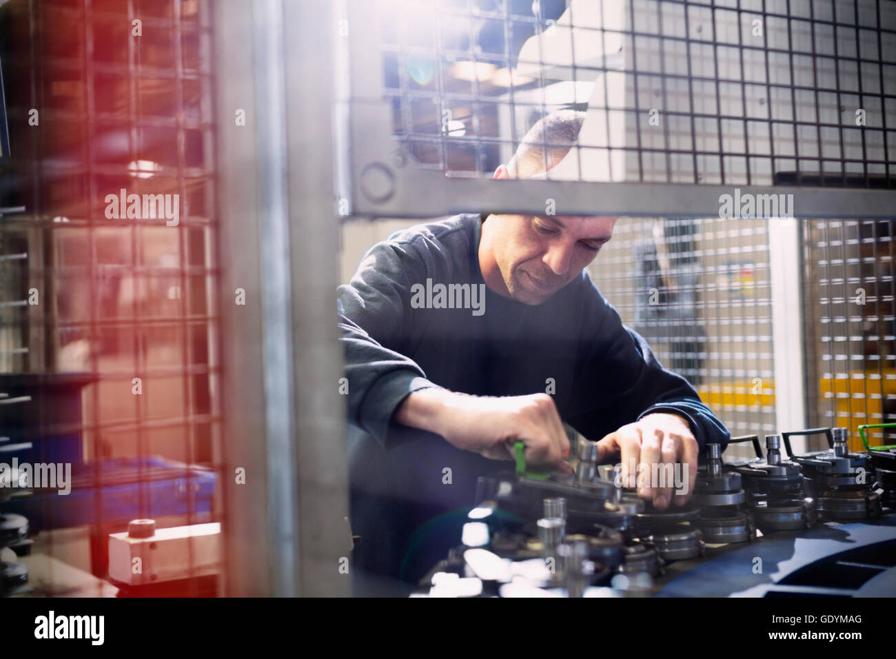 Worker repairing machinery in steel factory Stock Photo - Alamy