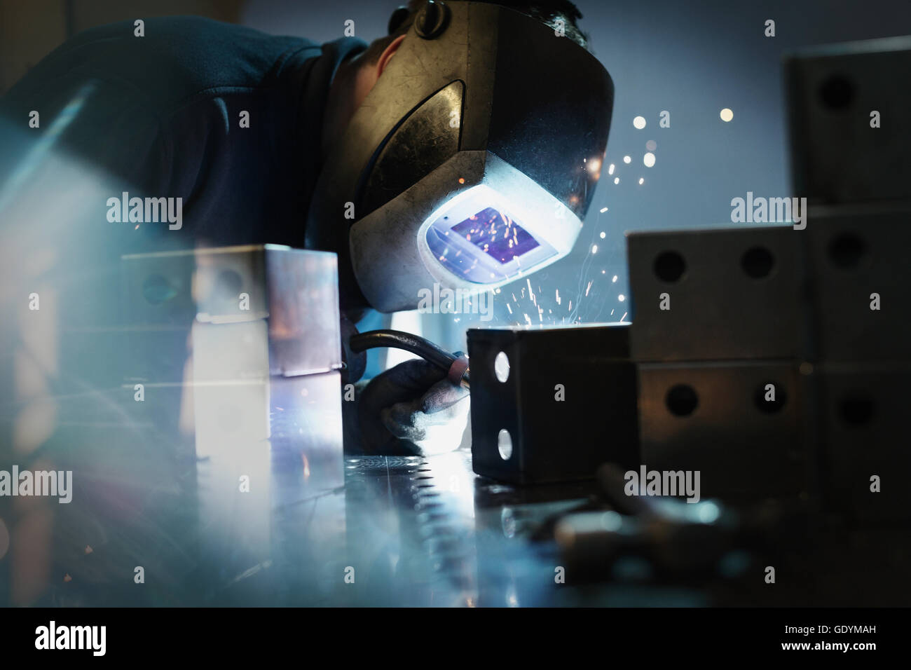 Welder using welding torch on steel in steel factory Stock Photo - Alamy