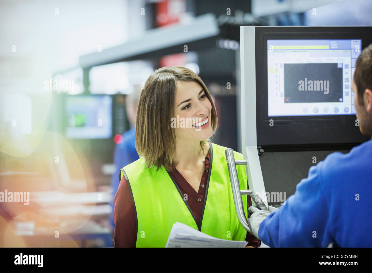 Smiling supervisor and worker at control panel in steel factory Stock ...