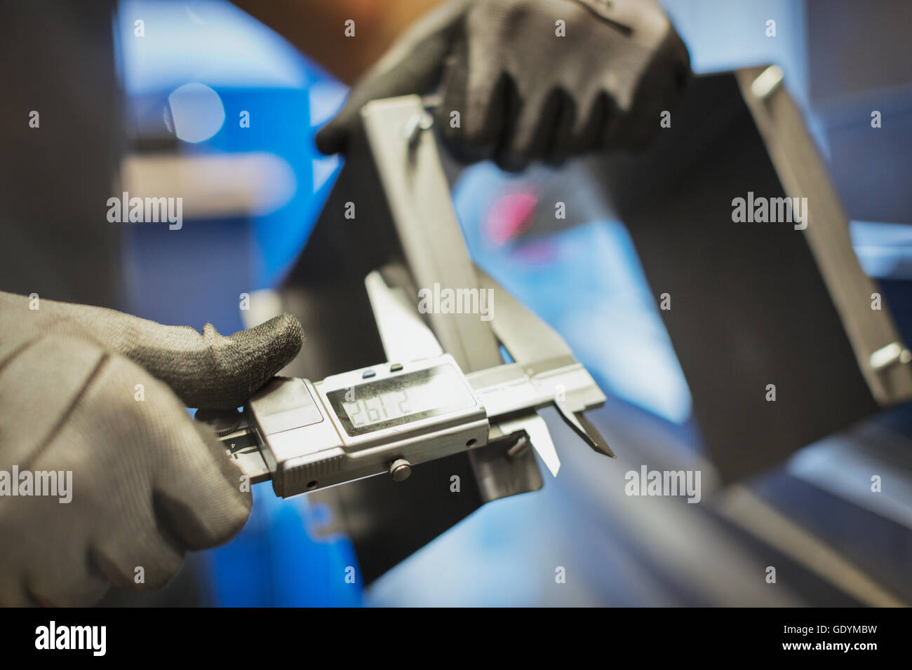 Worker measuring steel with calipers in steel factory Stock Photo - Alamy