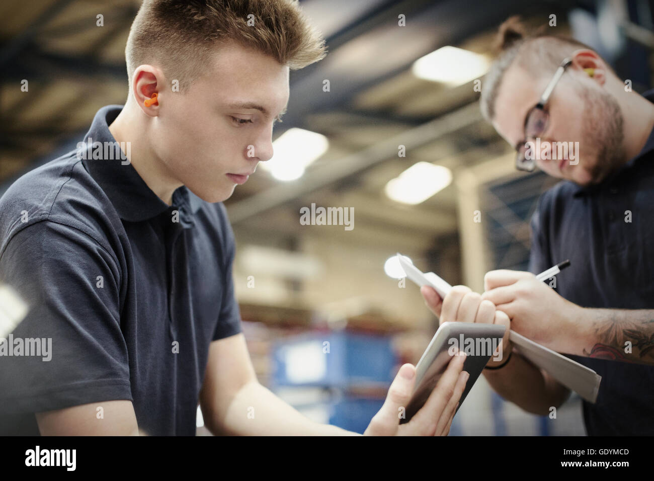 Workers with paperwork and digital tablet in steel factory Stock Photo ...