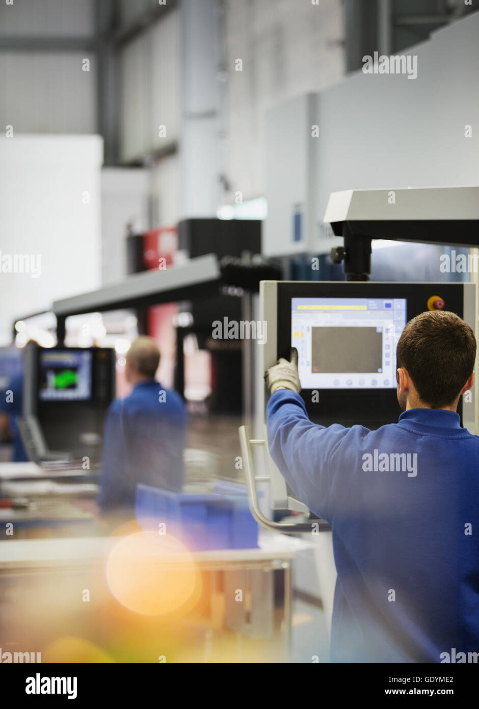 Worker at control panel in steel factory Stock Photo - Alamy