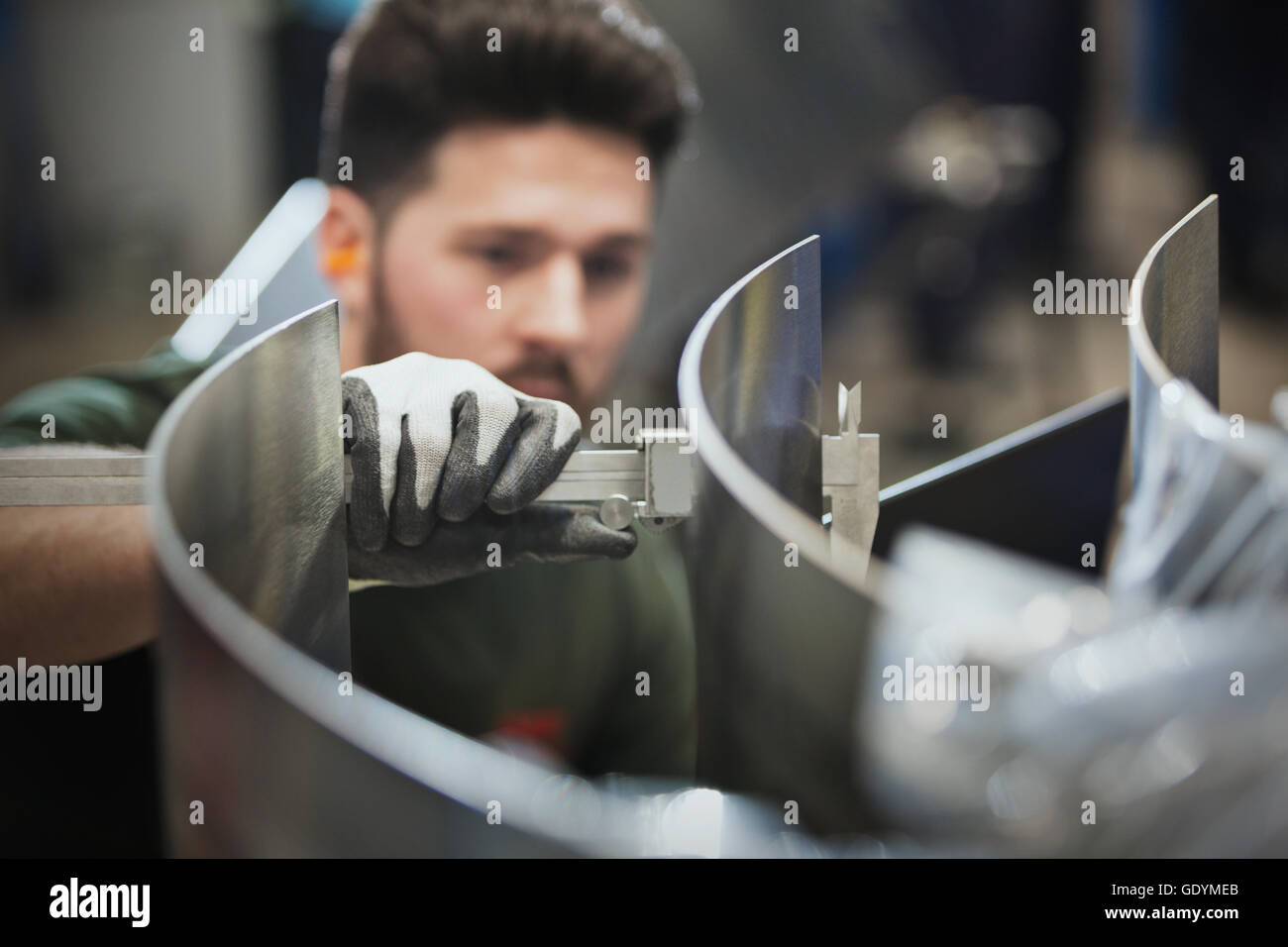 Worker measuring steel with calipers in steel factory Stock Photo - Alamy