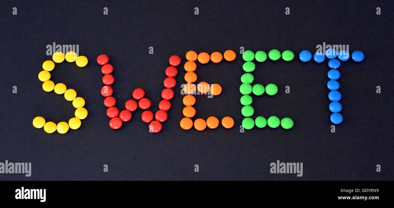 Closeup of the pile of colorful sweet bonbons with "SWEET" title Stock ...