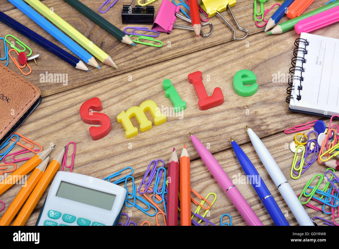 Smile word and office tools on wooden table Stock Photo - Alamy