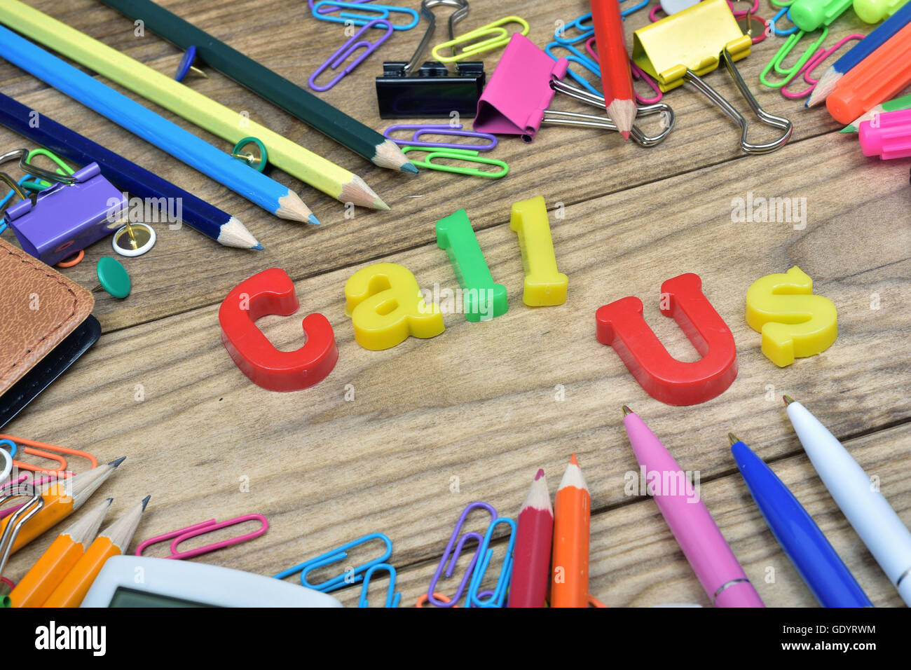 Call us word and office tools on wooden table Stock Photo - Alamy