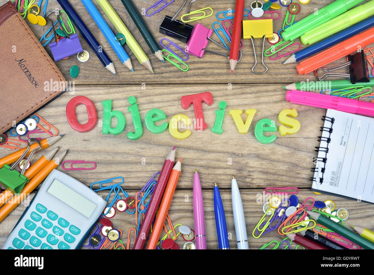 Objectives word and office tools on wooden table Stock Photo - Alamy