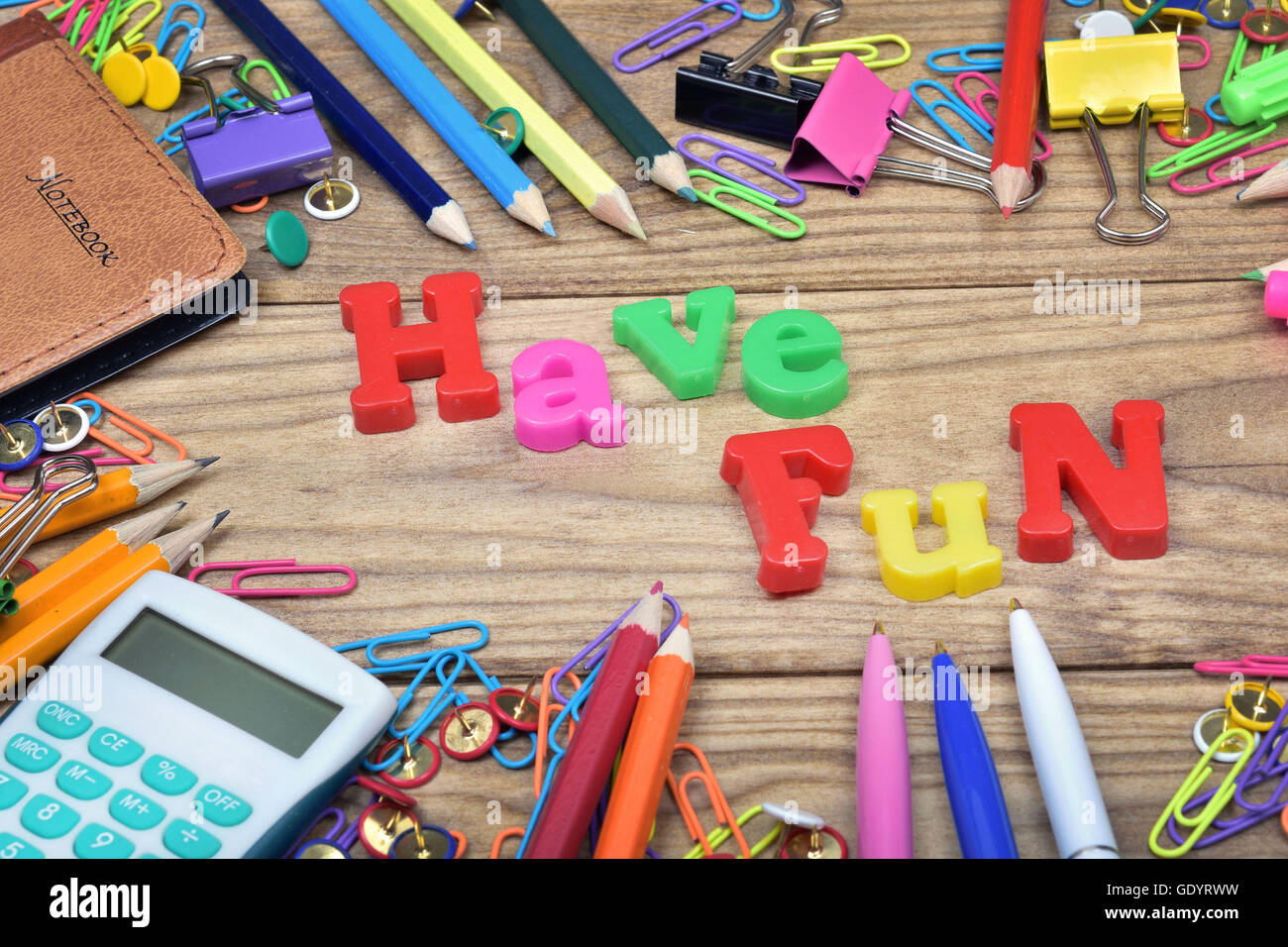Have Fun word and office tools on wooden table Stock Photo - Alamy