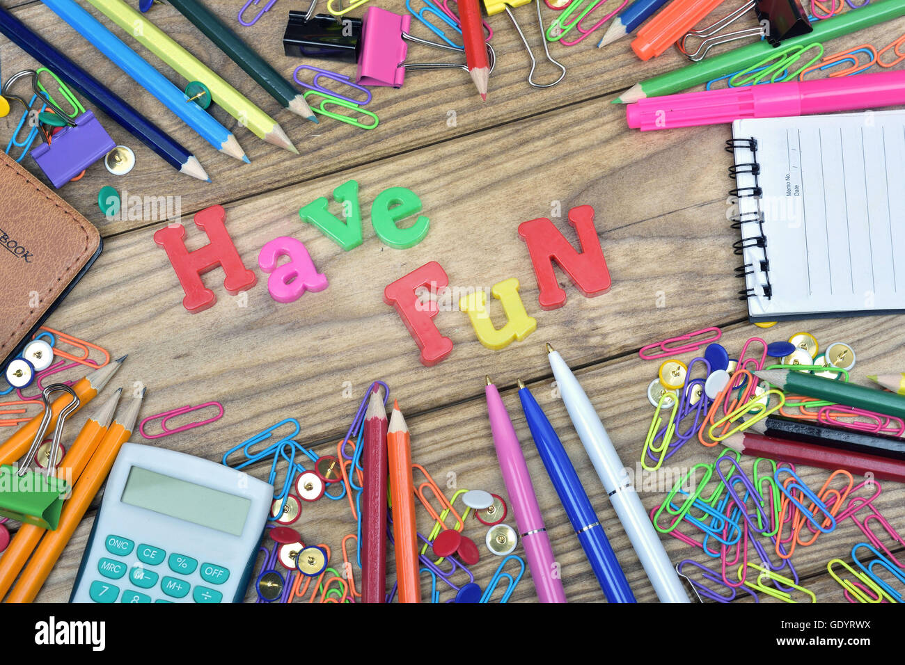 Have Fun word and office tools on wooden table Stock Photo - Alamy