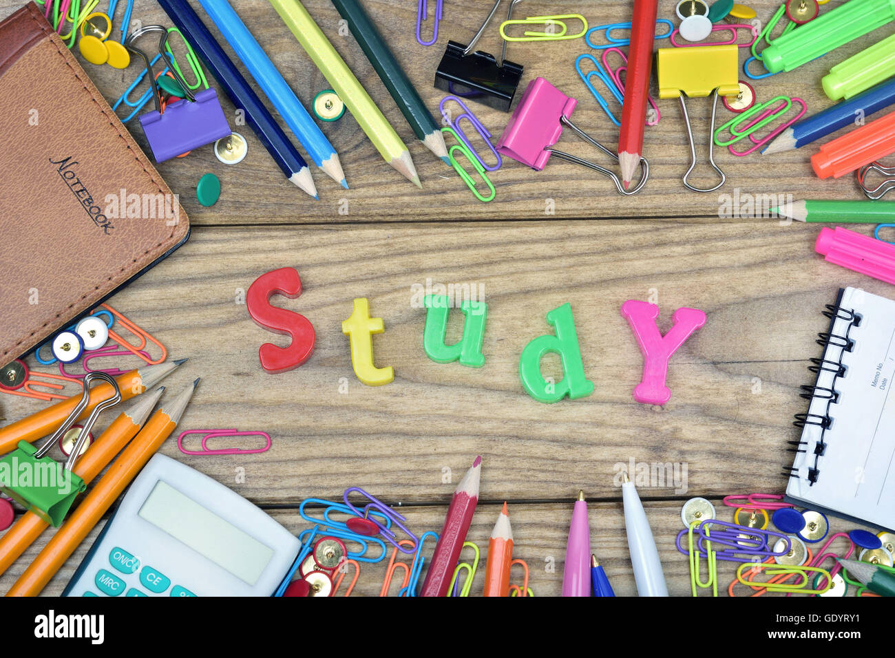Study word and office tools on wooden table Stock Photo - Alamy