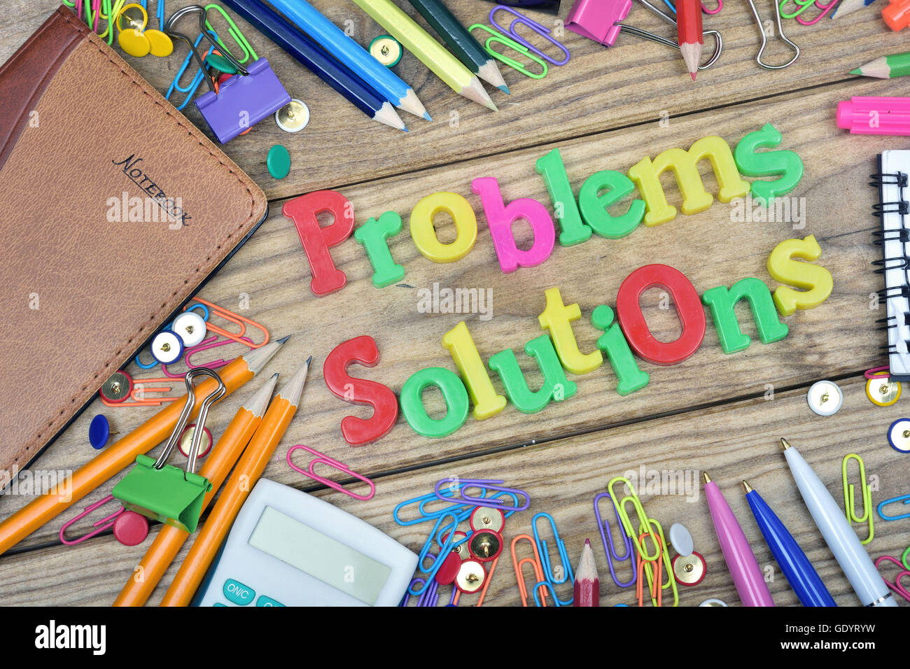 Problems Solutions words and office tools on wooden table Stock Photo ...