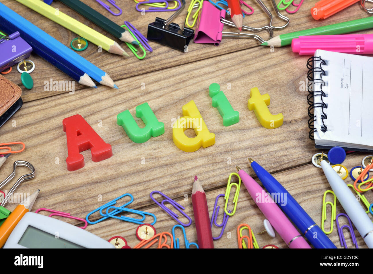 Audit word and office tools on wooden table Stock Photo - Alamy