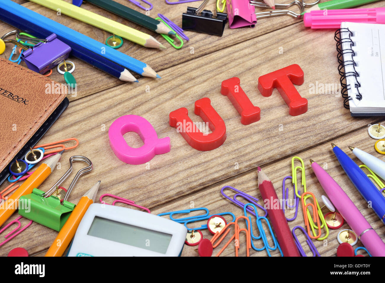 Quit word and office tools on wooden table Stock Photo - Alamy