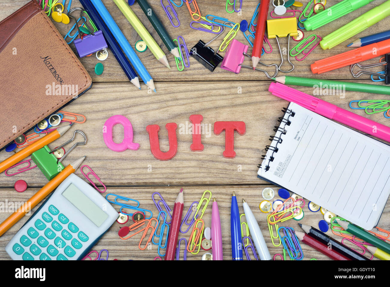 Quit word and office tools on wooden table Stock Photo - Alamy