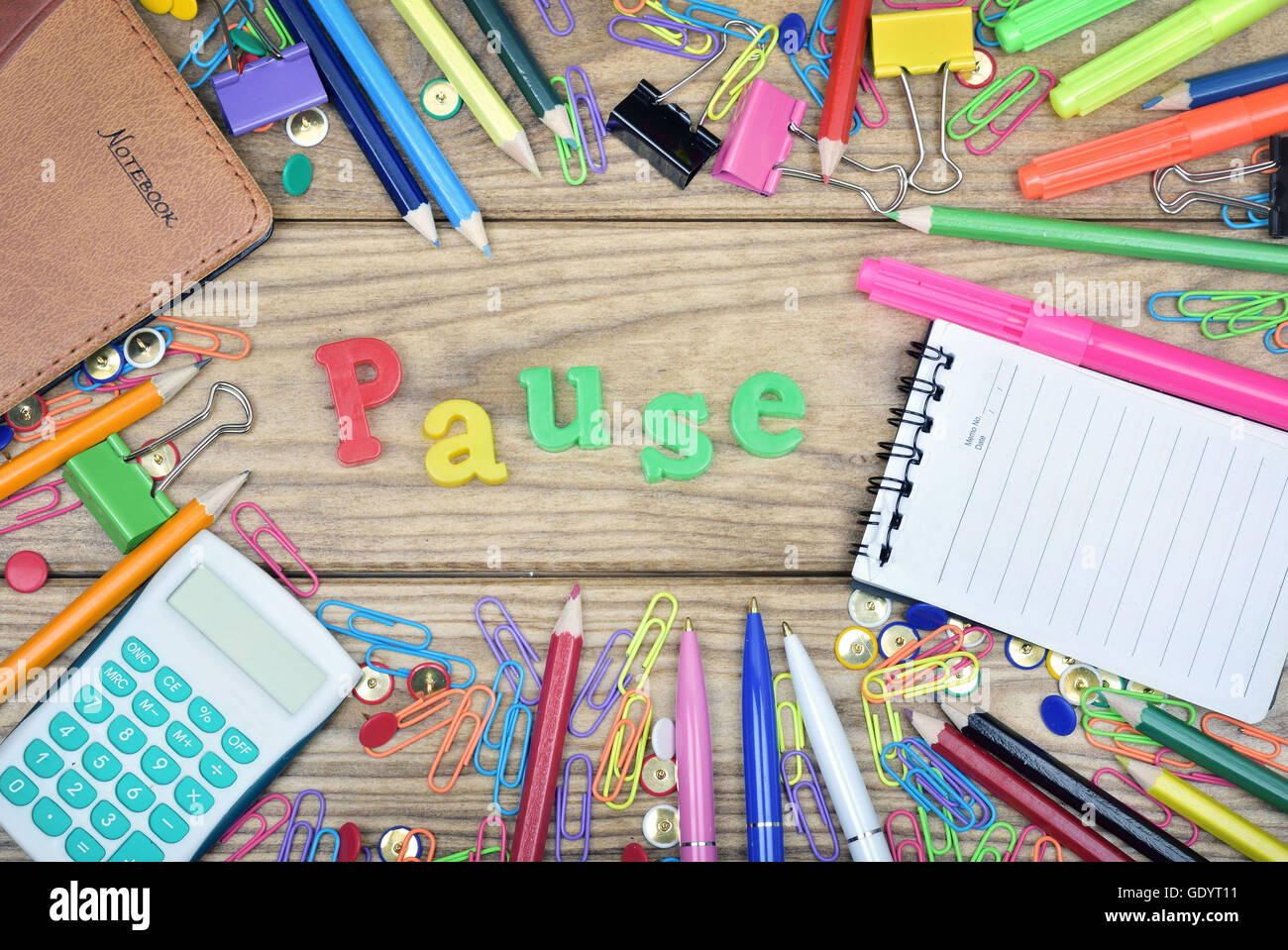 Pause word and office tools on wooden table Stock Photo - Alamy