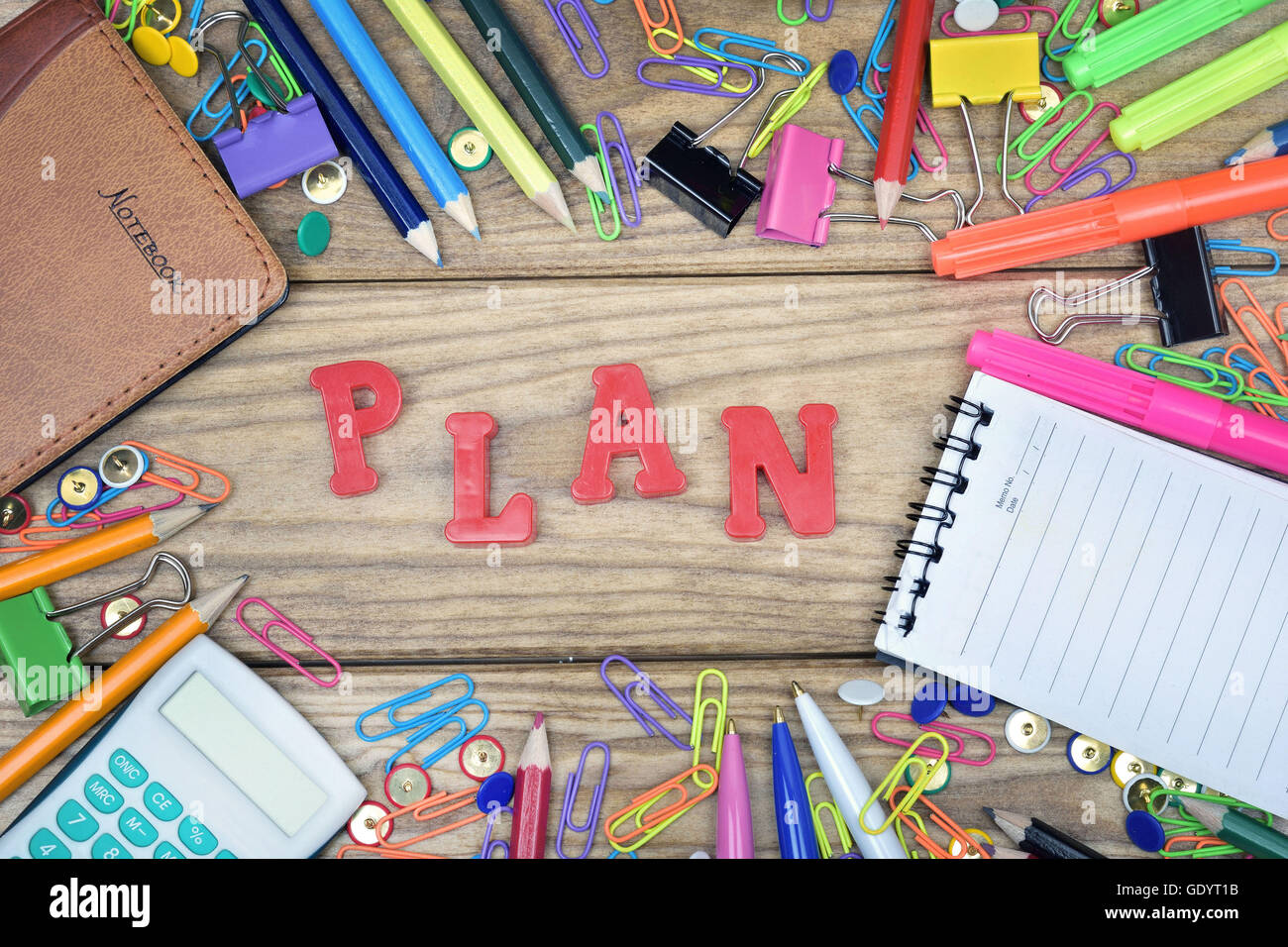 Plan word and office tools on wooden table Stock Photo - Alamy