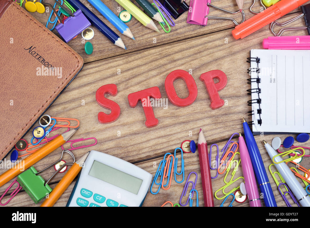 Stop word and office tools on wooden table Stock Photo - Alamy