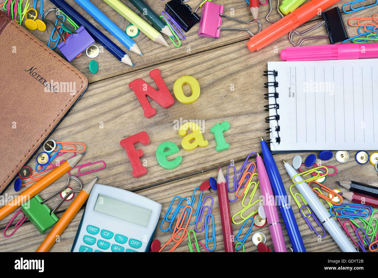 Fear word and office tools on wooden table Stock Photo - Alamy