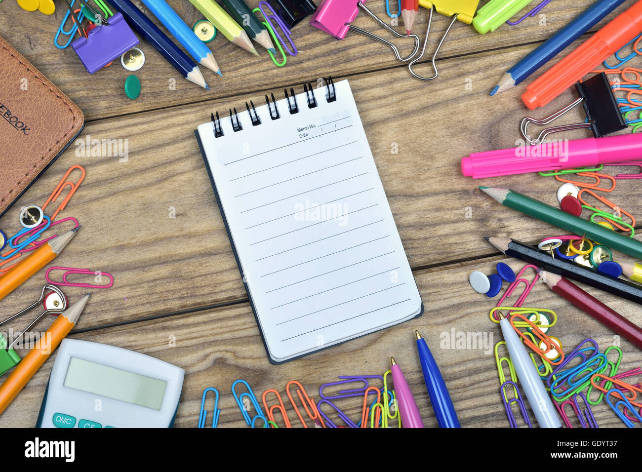 Notepad and office tools on wooden table Stock Photo - Alamy