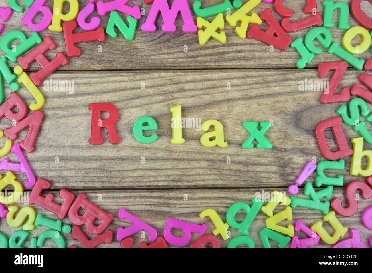 Relax word on wooden table Stock Photo - Alamy