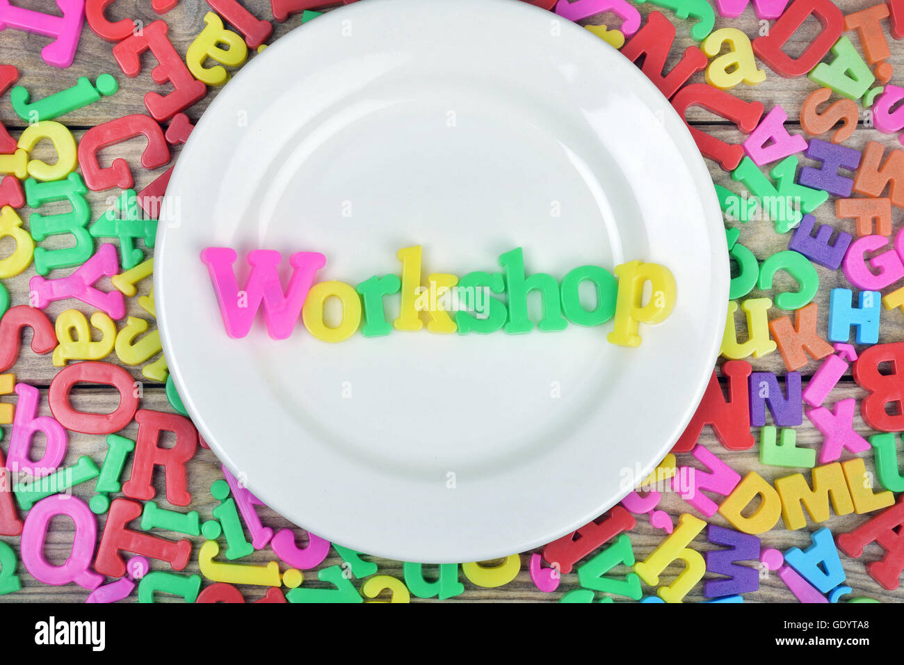 Workshop word on white plate and magnetic letters Stock Photo - Alamy