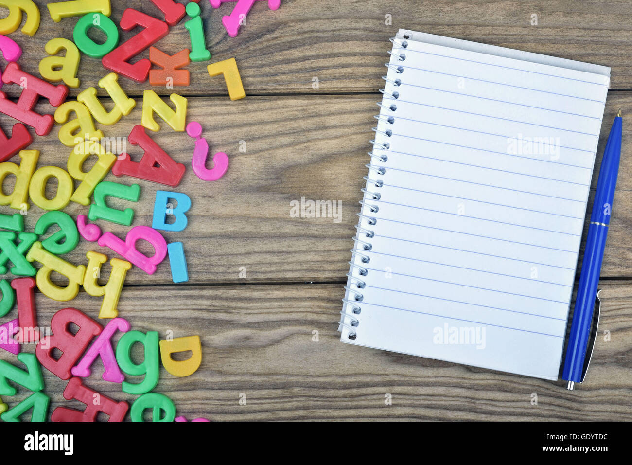 Notepad and many letters on wooden table Stock Photo - Alamy