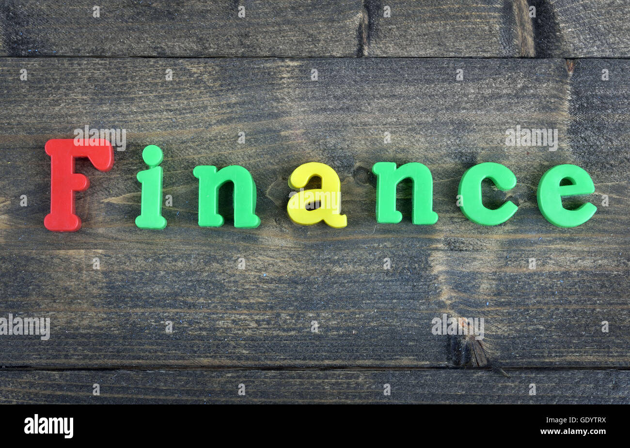 Finance word on wooden table Stock Photo - Alamy