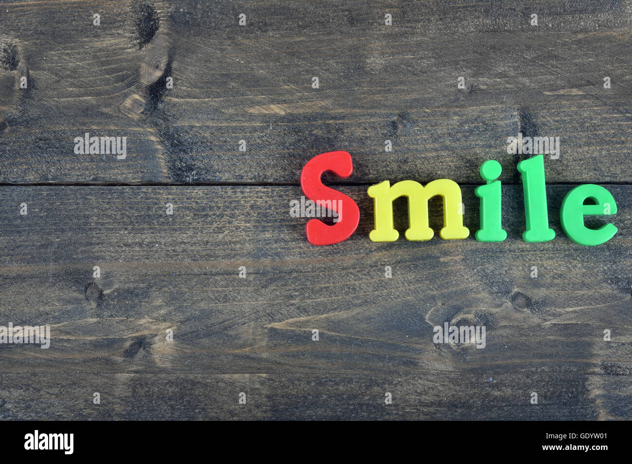 Smile word on wooden table Stock Photo - Alamy