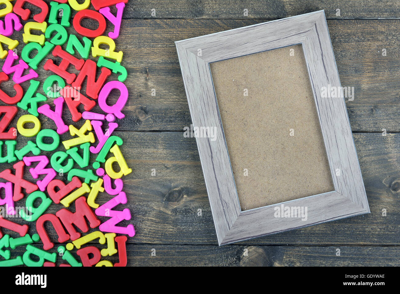 Photo frame word on wooden table Stock Photo - Alamy
