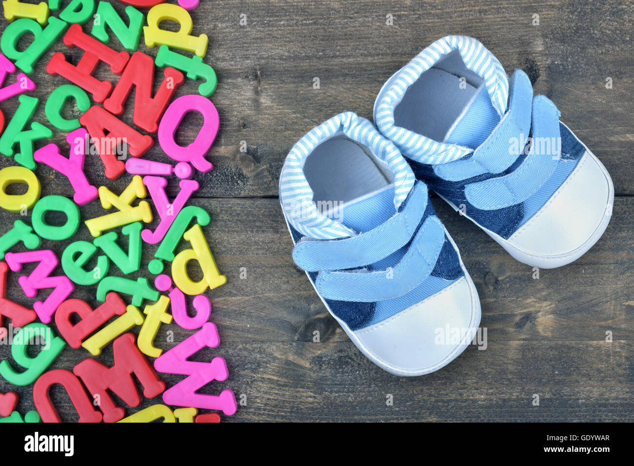 Kids shoes word on wooden table Stock Photo - Alamy