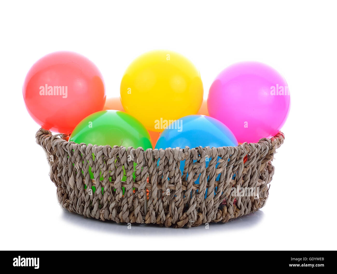 Colorful plastic toy balls in basket on white background Stock Photo ...