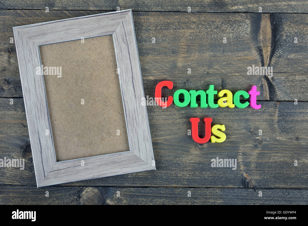 Contact us word on wooden table Stock Photo - Alamy