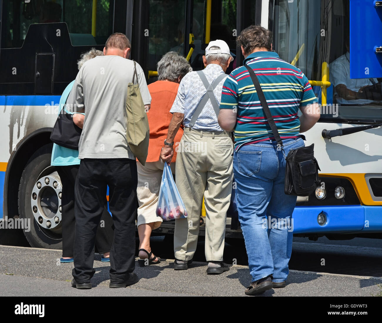 People getting in to the bus at the bus stop Stock Photo - Alamy