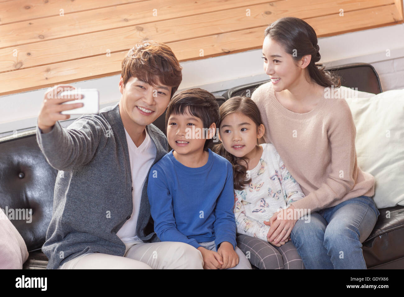 Harmonious family posing to take picture of themselves with a ...