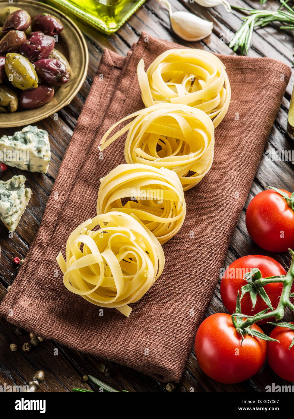 Pasta ingredients. Cherry-tomatoes, spaghetti pasta, rosemary and ...