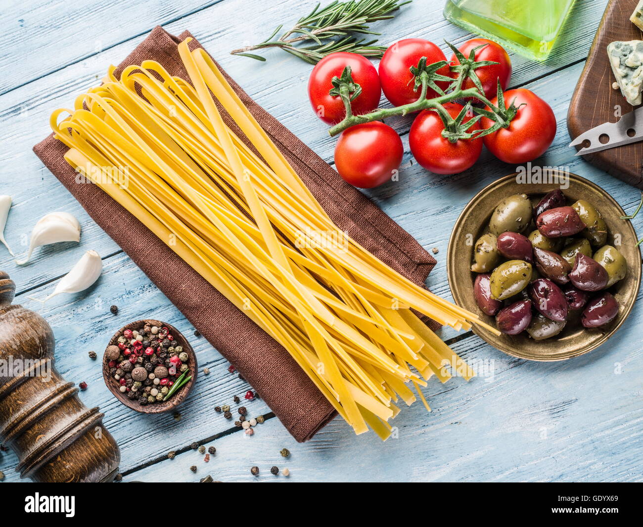 Pasta ingredients. Cherry-tomatoes, spaghetti pasta, rosemary and ...