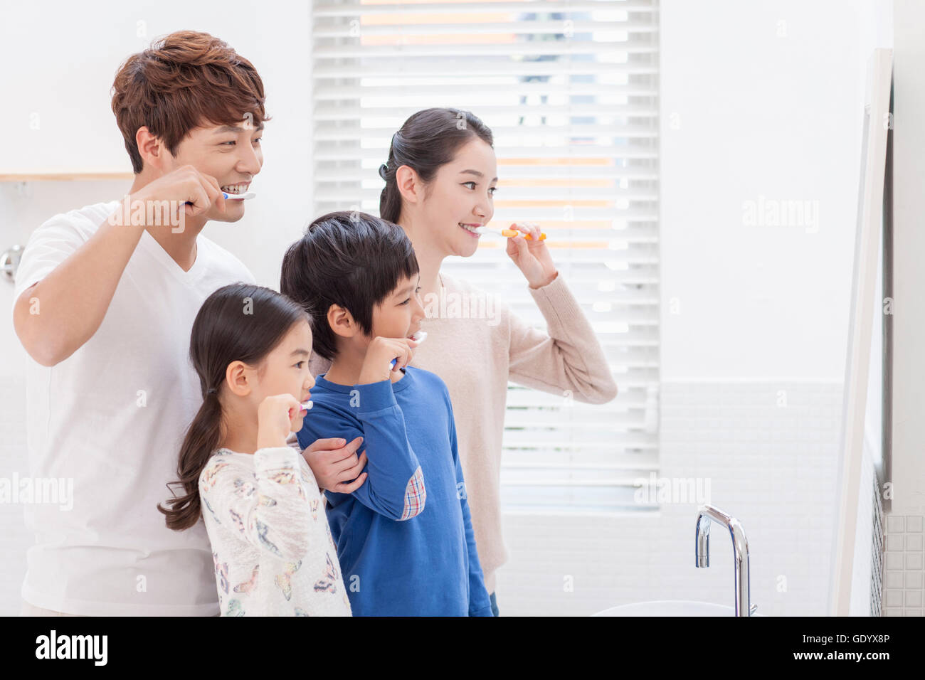 Side view portrait of smiling family brushing their teeth Stock Photo ...