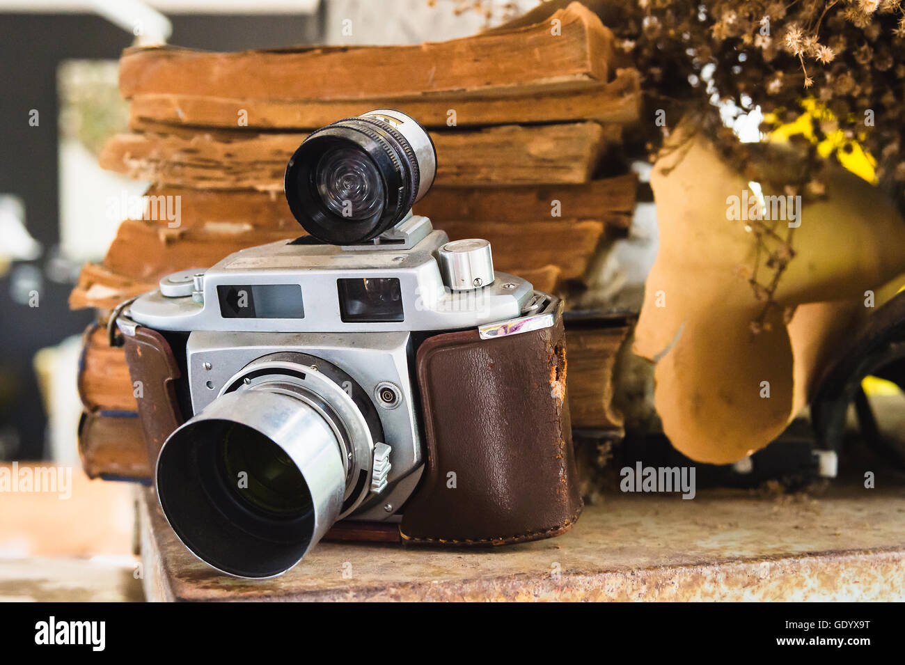 Old camera, stack old books background Stock Photo - Alamy