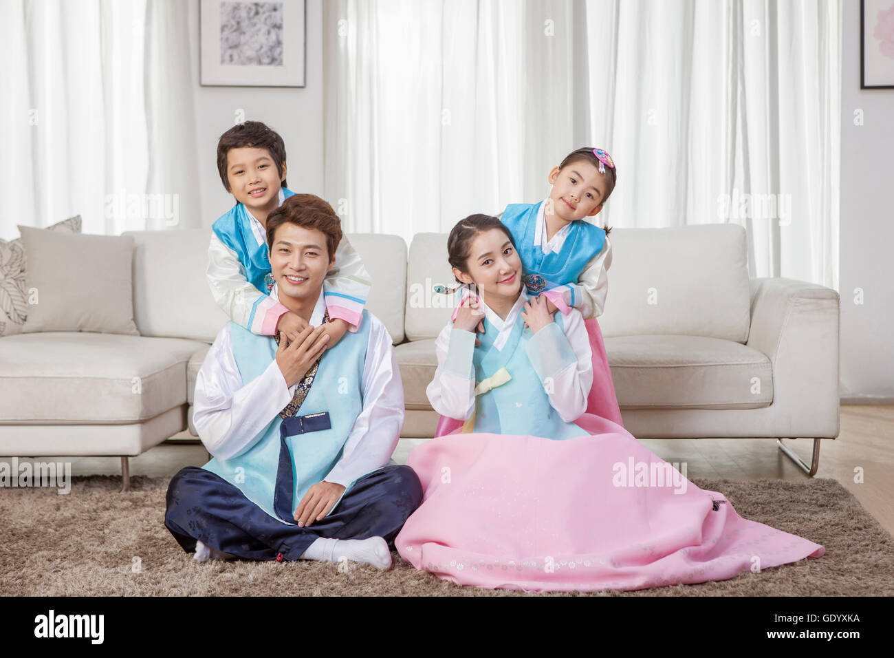 Harmonious family in traditional Korean clothes in living room Stock ...