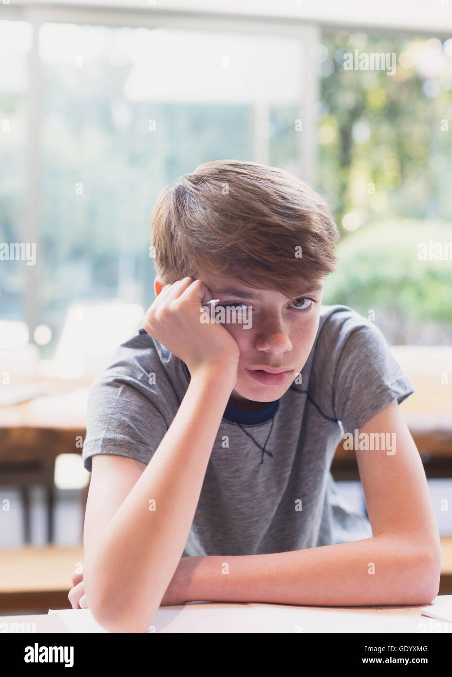 Portrait of bored boy doing homework Stock Photo - Alamy