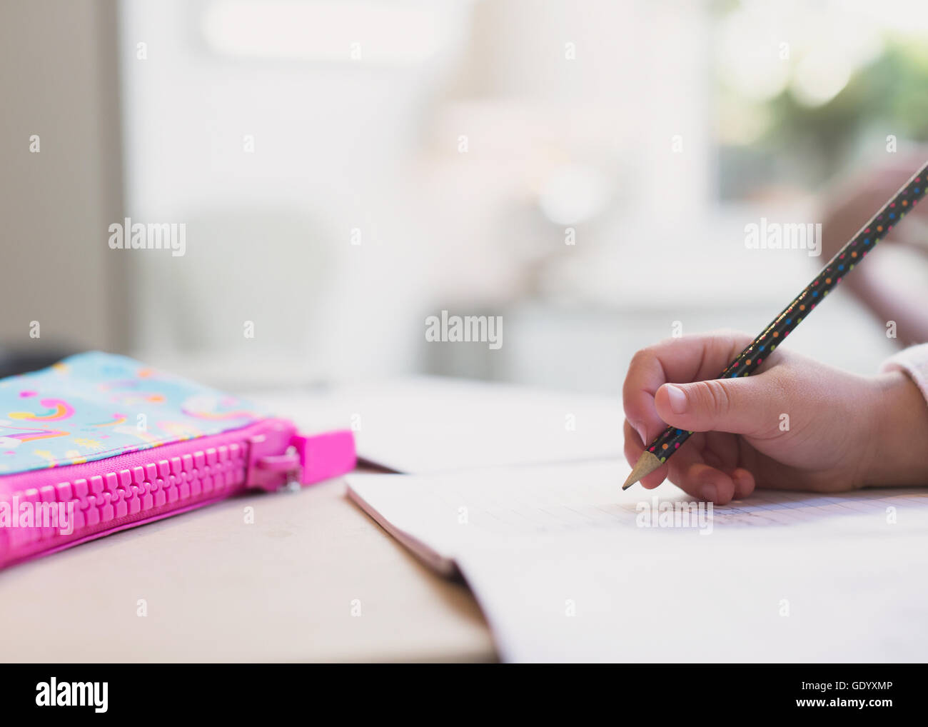 Close up girl doing homework with pencil Stock Photo - Alamy