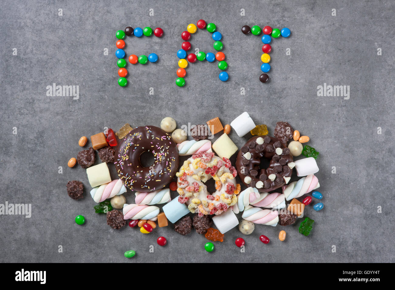 Typographical word of FAT made of chocolates and various high-calorie ...