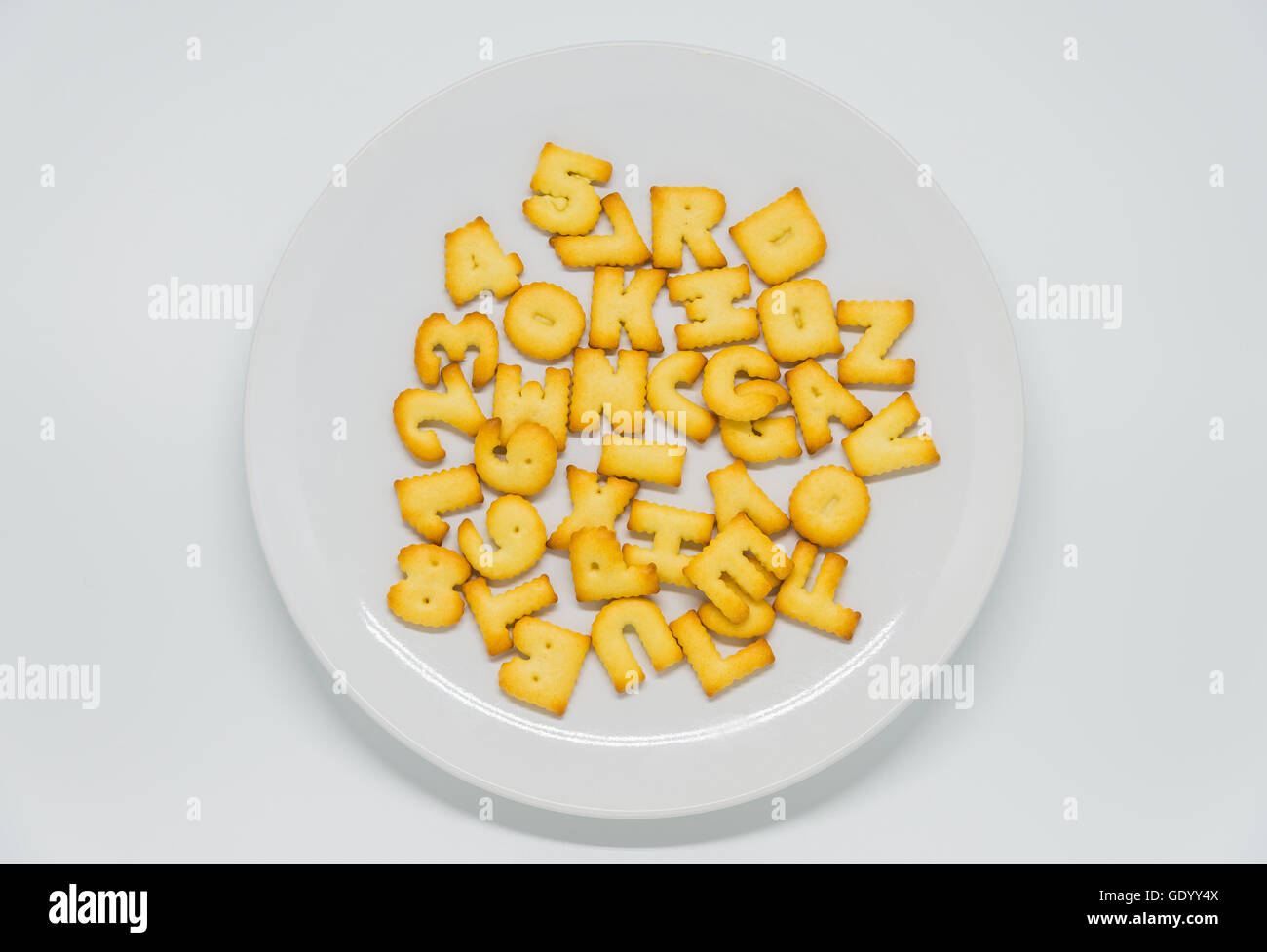 Alphabet cracker in dish with white background 2 Stock Photo - Alamy