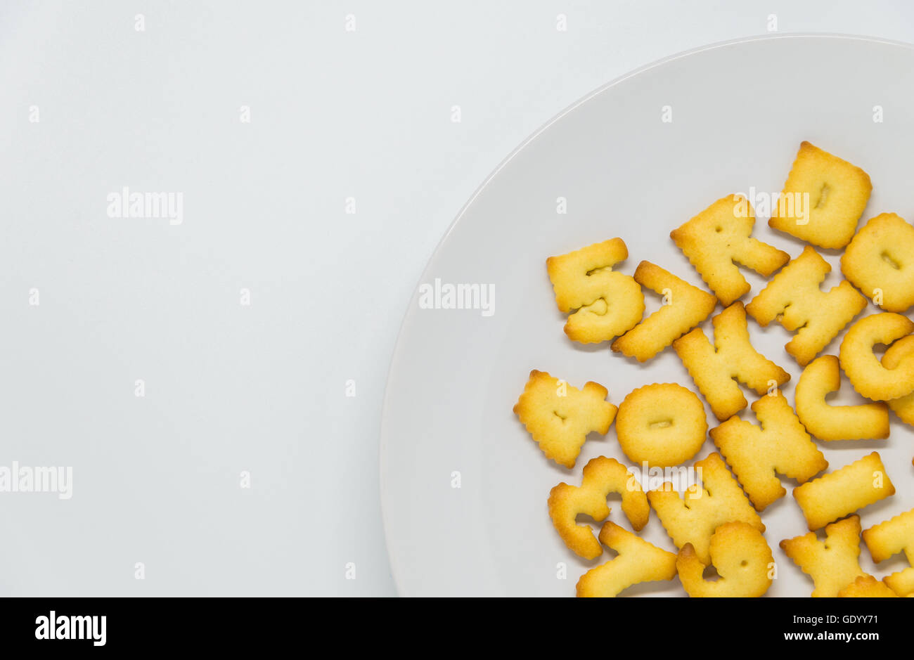 Alphabet cracker in dish with white background Stock Photo - Alamy