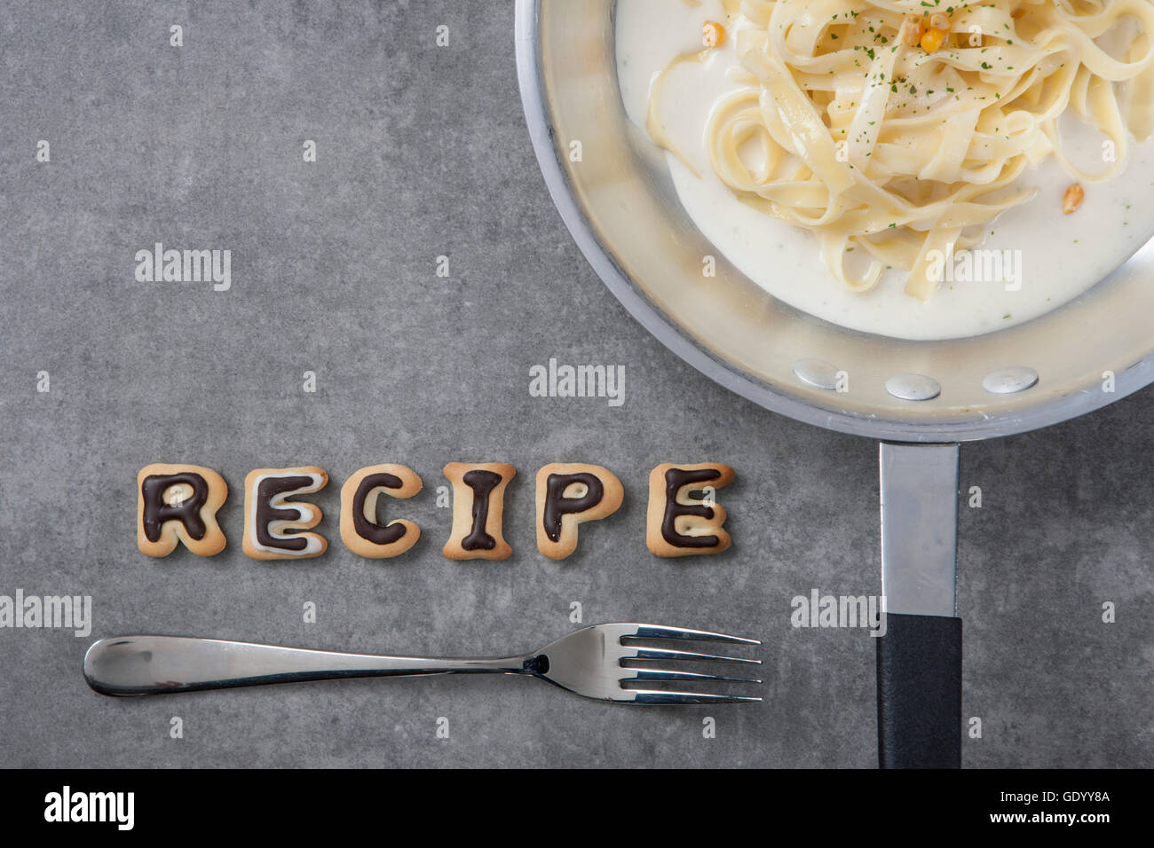 Typographical word of RECIPE made of alphabet cookies with a fork and ...