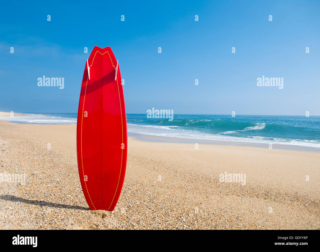 Beach landscape with a red surfboard on the sand Stock Photo - Alamy