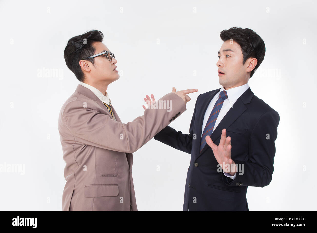 Side view portrait of two business men having a fight face to face ...