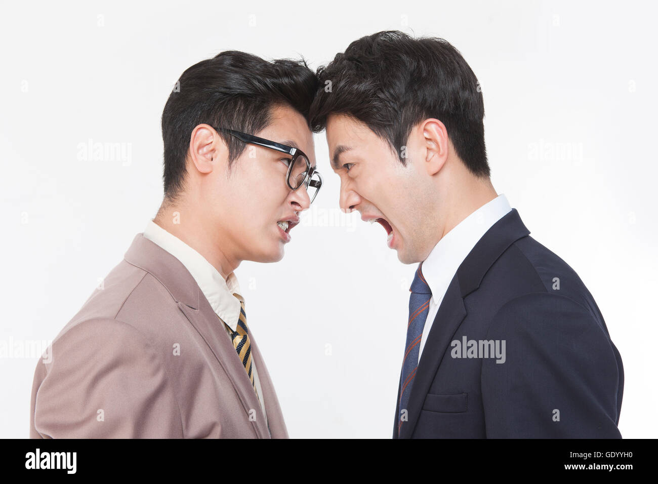 Side view portrait of two business men mad at each other face to face ...